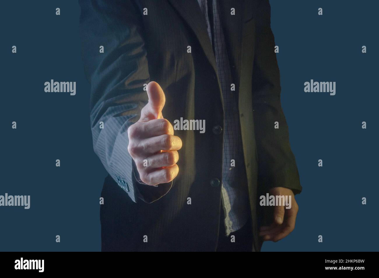 A man in a suit shows a great sign. A sign of success and good luck. A ...