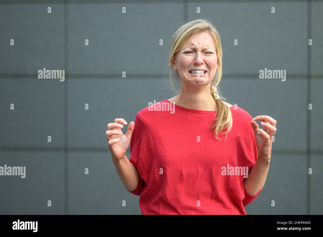 Crying young blond woman in pain with big tears expressing her ...