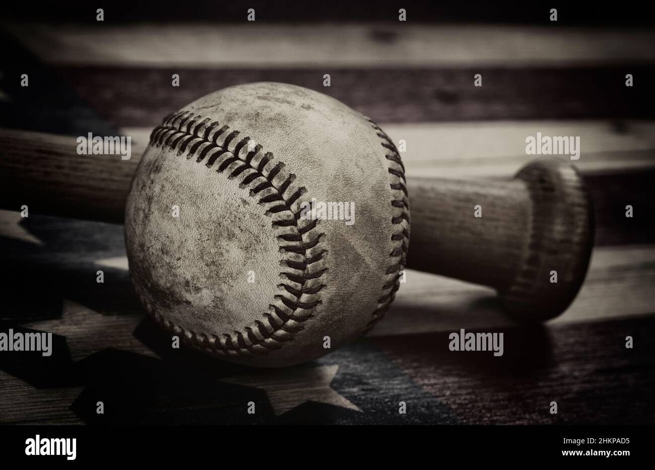 Closeup view of an old baseball and traditional wood bat on rustic ...