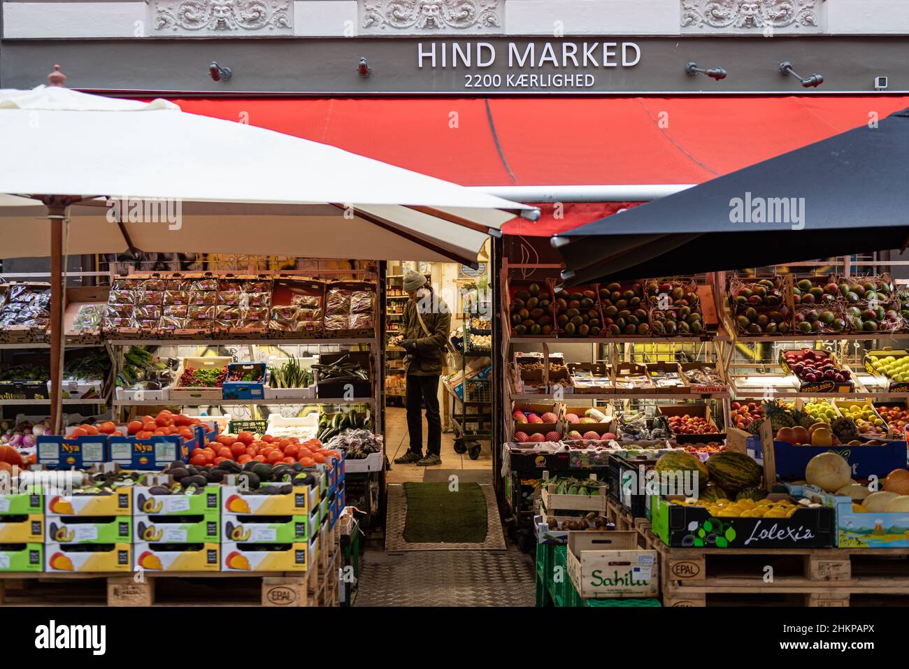 a small variety store door is open for customers to enter unmasked ...