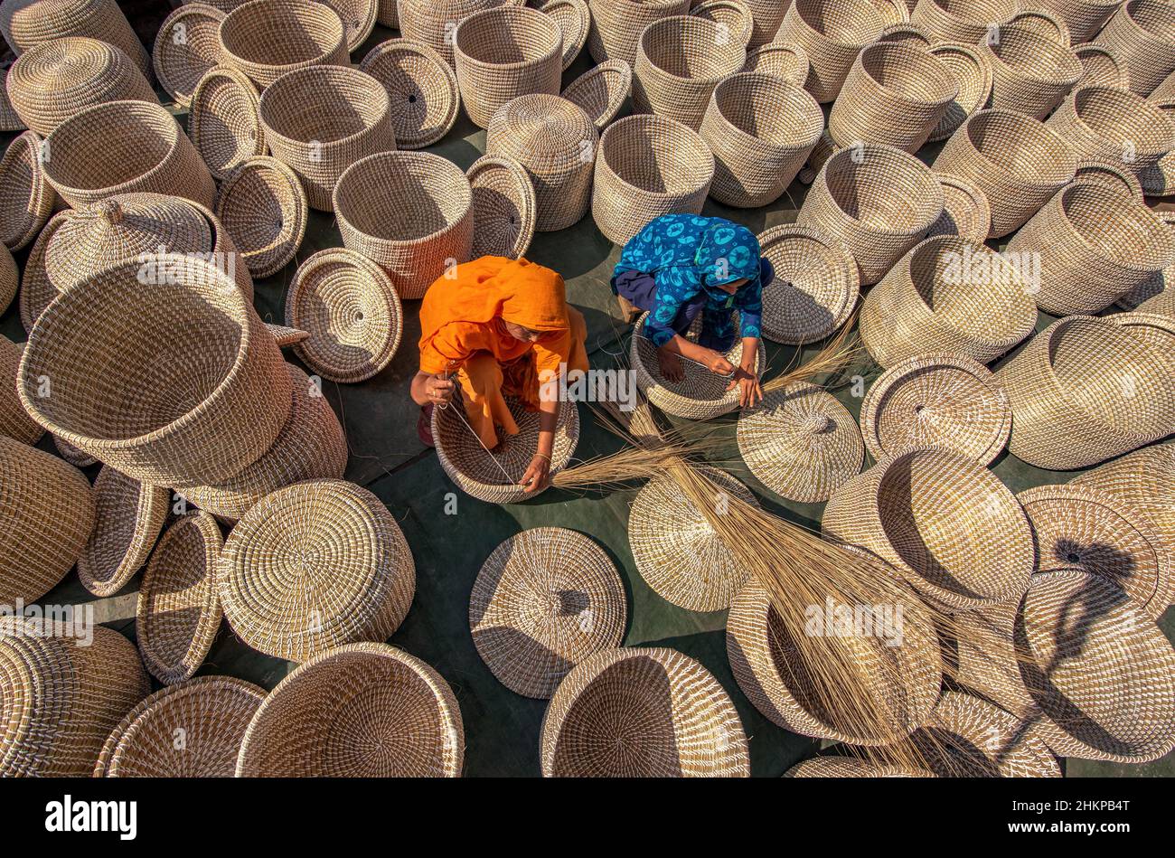 Thousands of freshly handwoven baskets dry in the sun before being ...