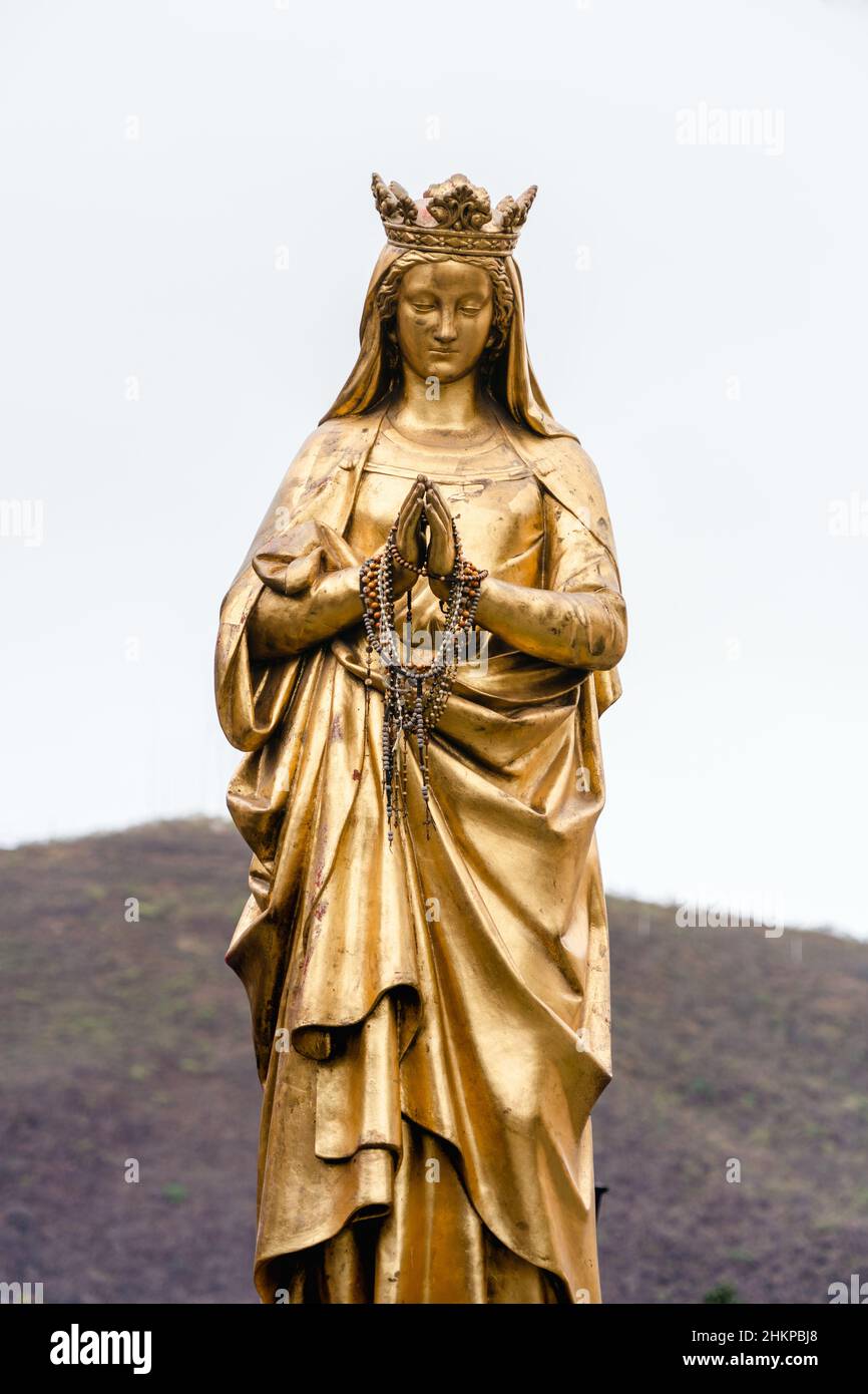 Vertical shot of the golden statue of Mary Stock Photo - Alamy