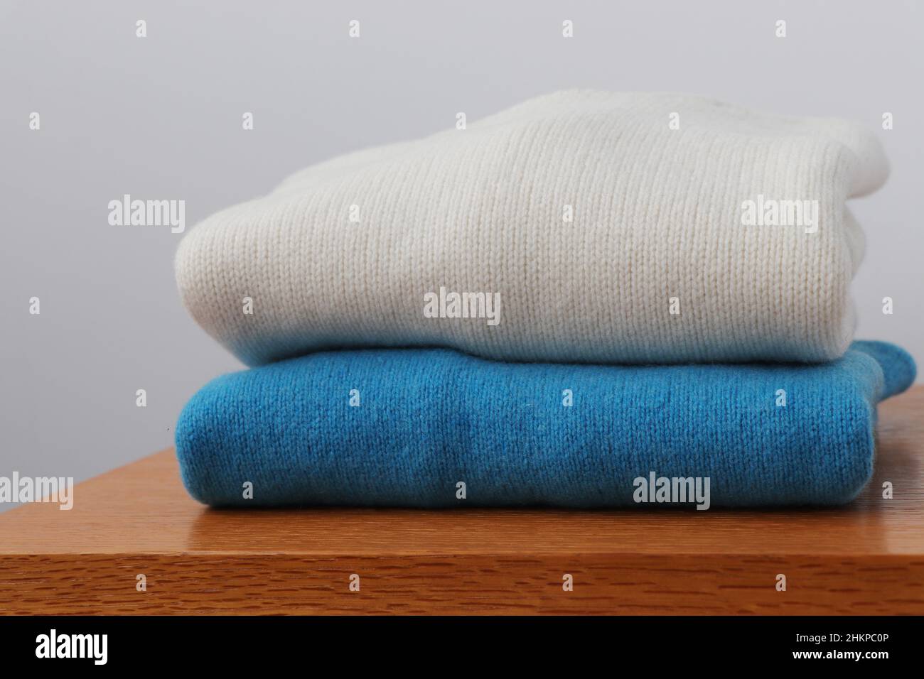 Folded sweaters from dark to light colour made of wool and cashmere ...