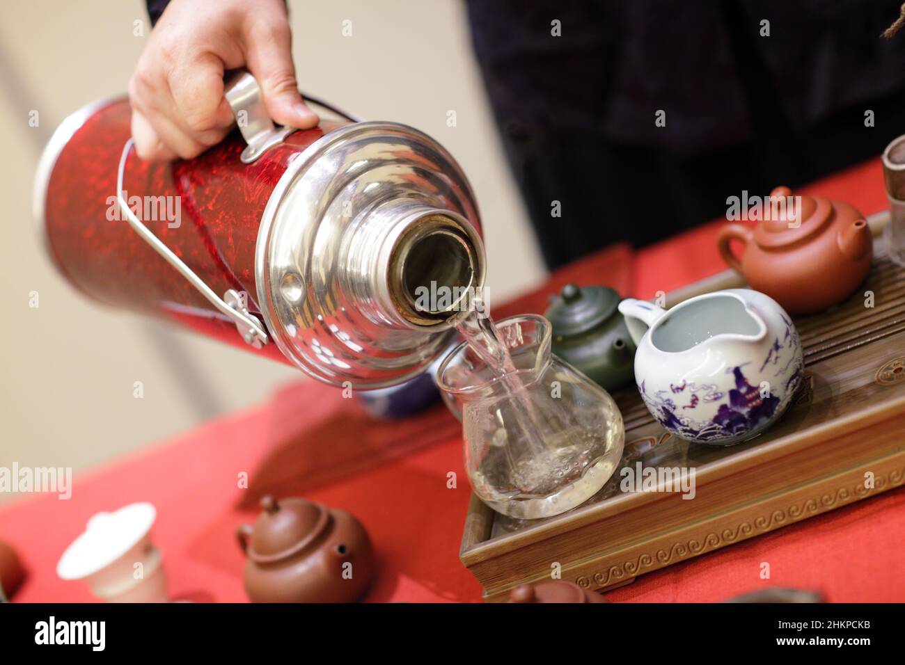 Man pours boiling water into jug from thermos at the Tea Ceremony Stock ...