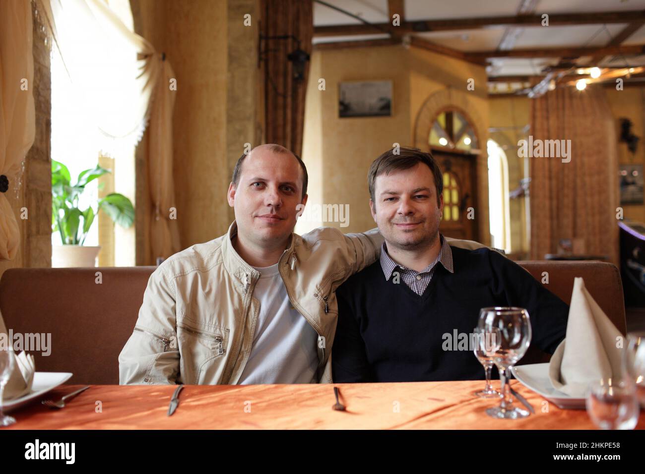 Two friends are posing in the restaurant Stock Photo - Alamy