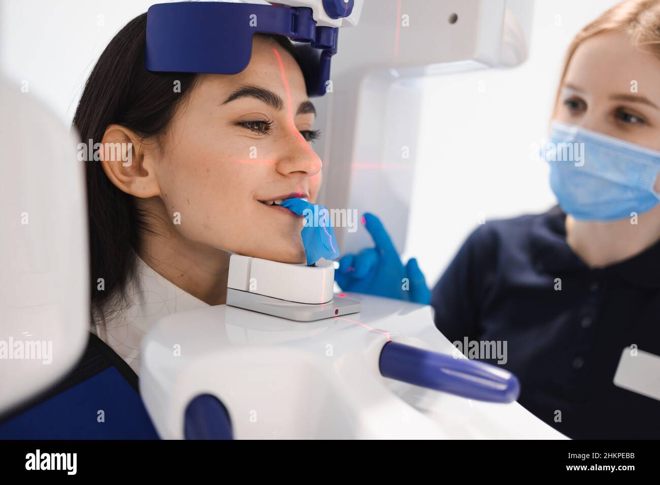 Female patient make a dental computer tomograph. The radiologist makes ...