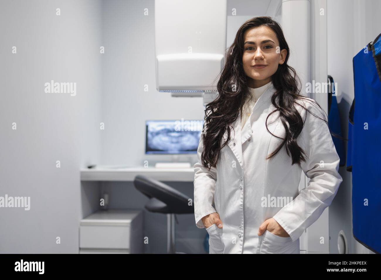 Portrait of female medic in CT scan room. Woman near the tomograph ...