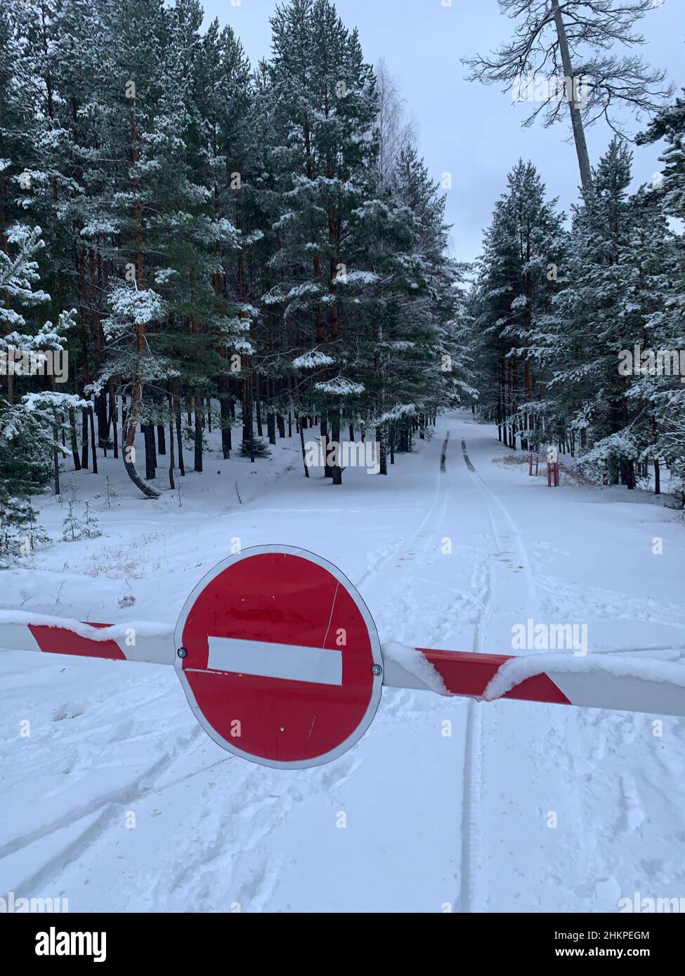 Road Barrier with brick, stop sign in winter forest Stock Photo - Alamy