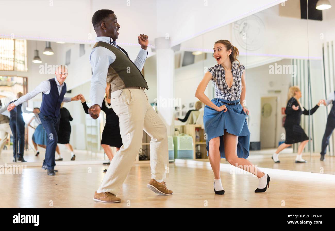 Woman with african man practising charleston dancing Stock Photo - Alamy