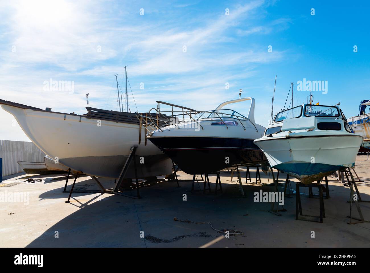 Boat on the stand in the marine workshop on the beautiful sunny day, a ...