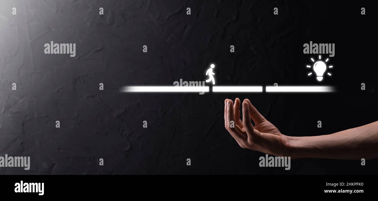 Male business man hand hold a connecting block between two sets of ...