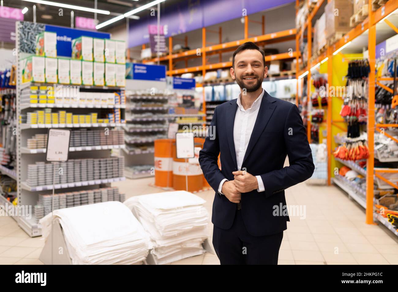 half-length portrait of a hardware store owner with a smile on his face ...