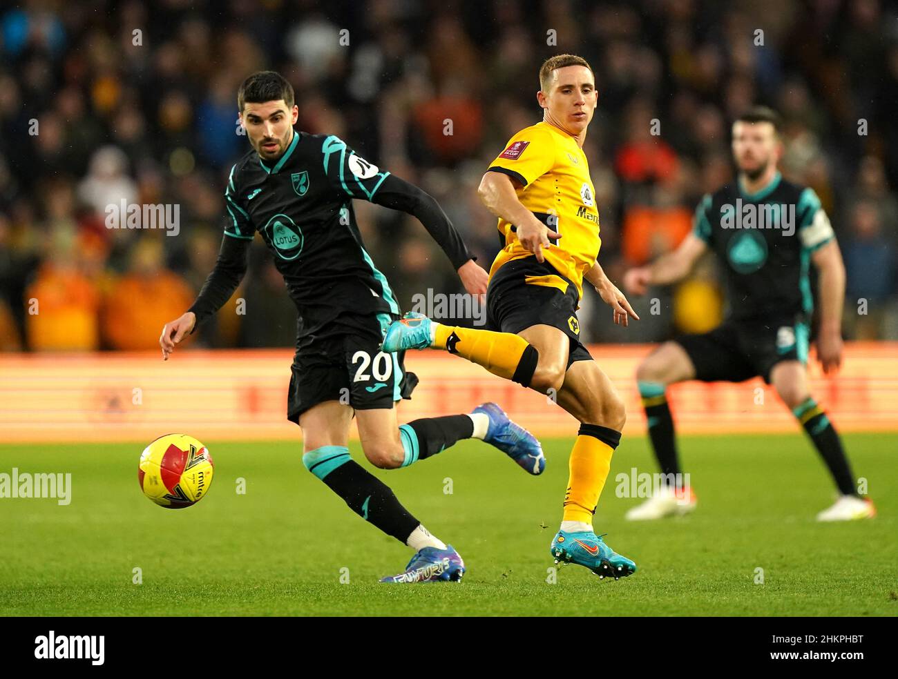 Wolverhampton Wanderers' Daniel Podence (right) back heels the ball ...