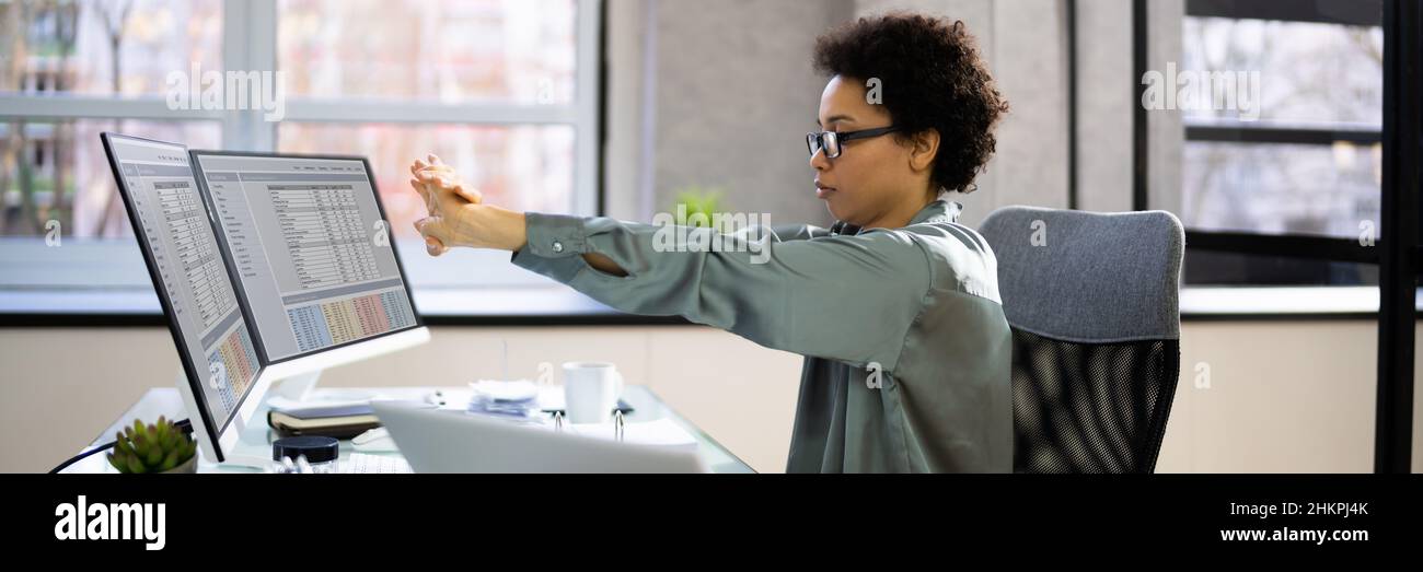 Arms Stretch Exercise Sitting At Desk In Office Stock Photo - Alamy