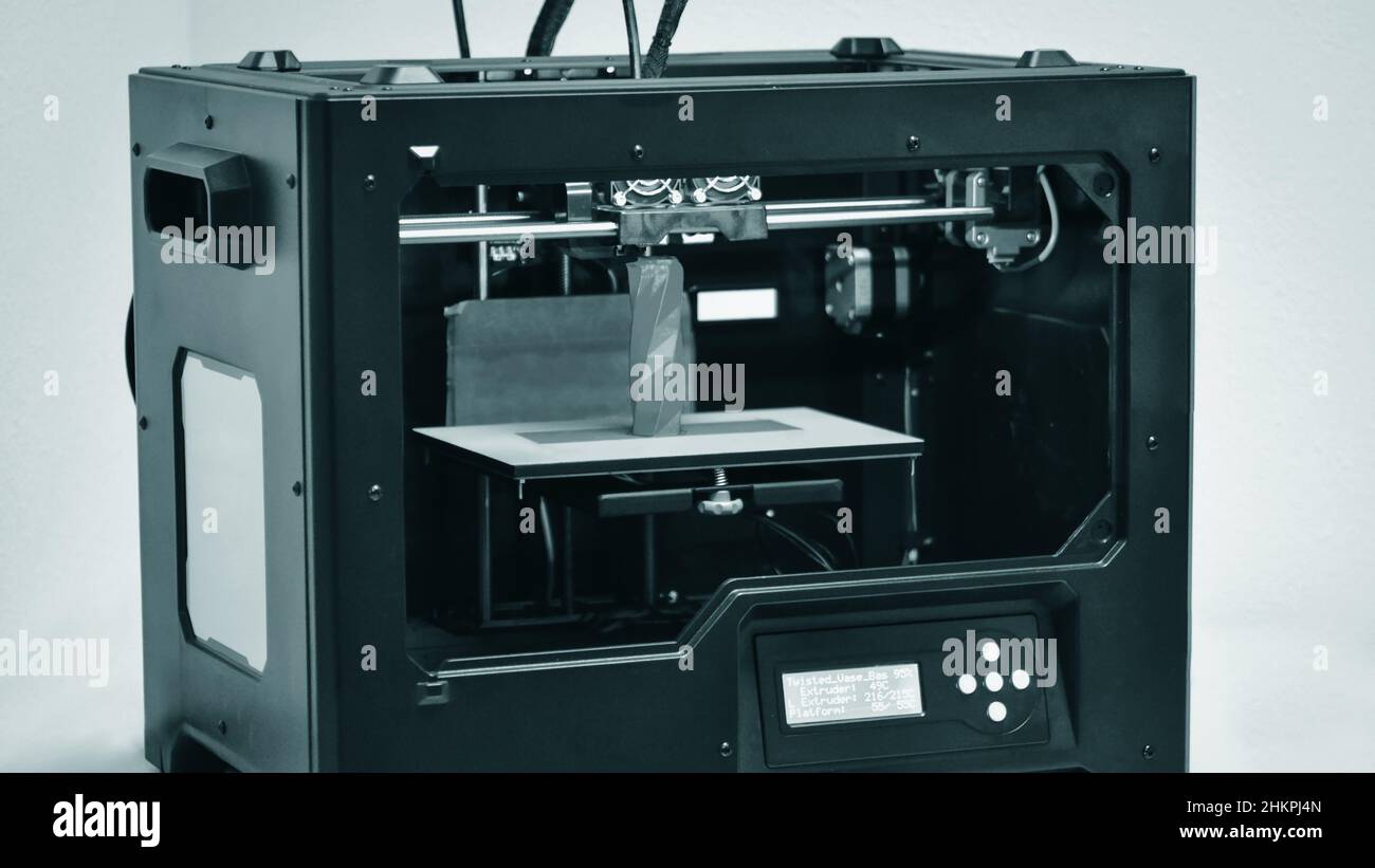 3D printer works and creates an object from the hot molten plastic ...