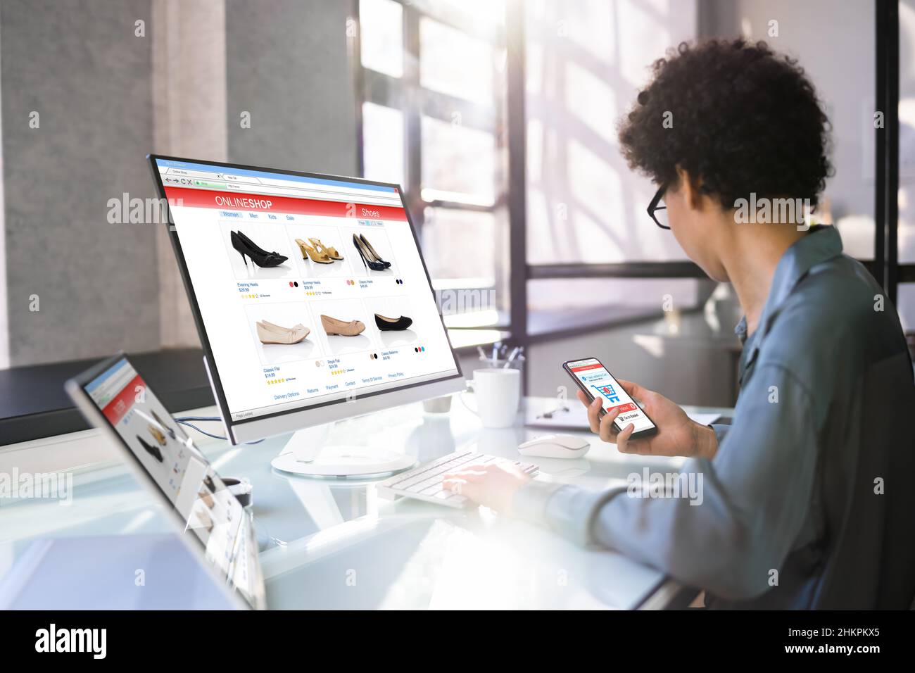 African American Woman Shopping On Computer And Phone Stock Photo - Alamy