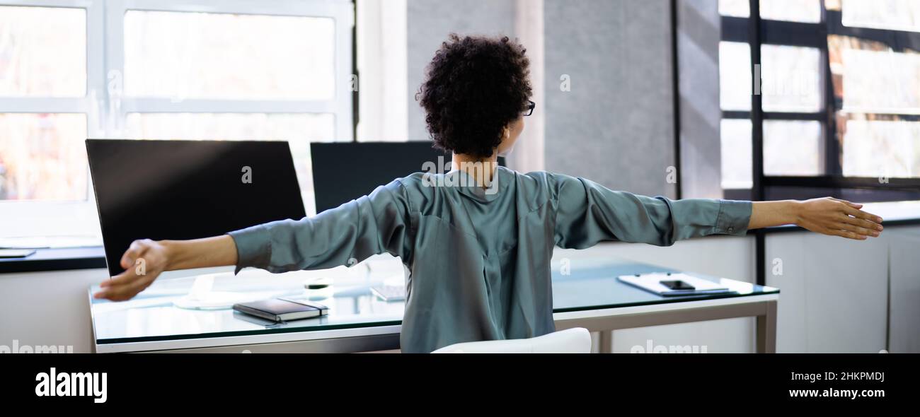 Stretching Arms In Office At Desk Rear View Stock Photo - Alamy