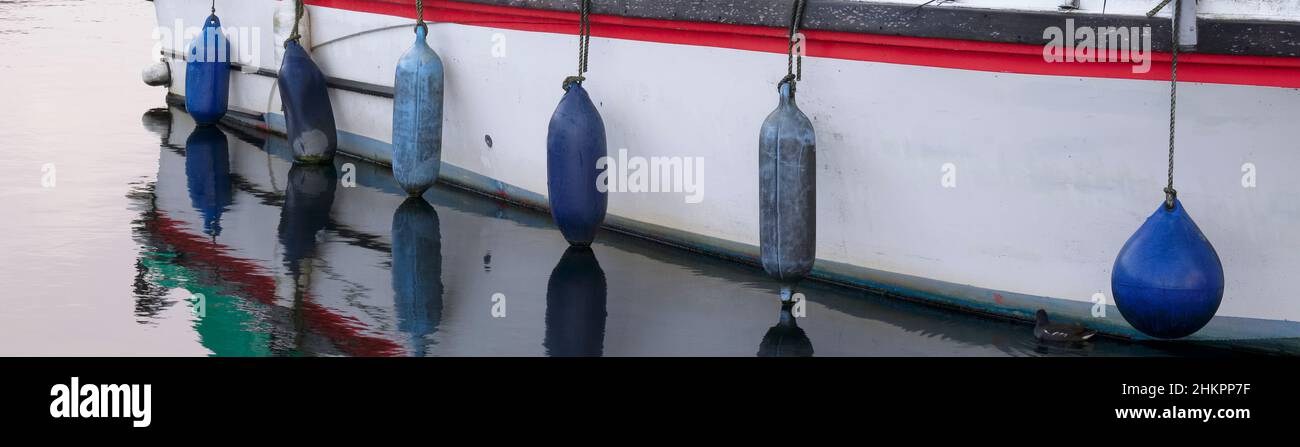 Barge boat with buoy floats along side on canal Stock Photo - Alamy