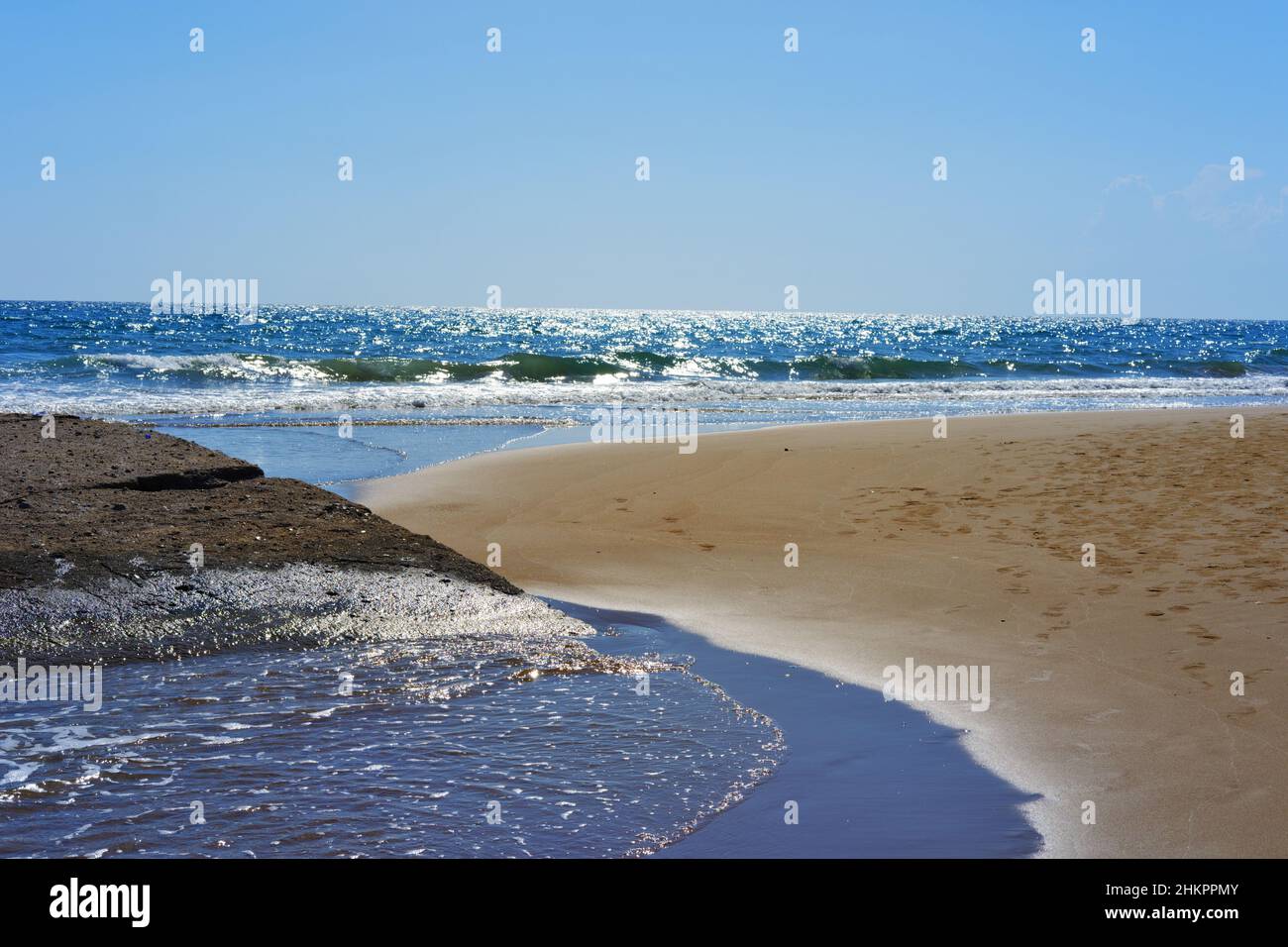 Waves at beautiful sandy beach in a sunny summer day in Antalya Turkey ...