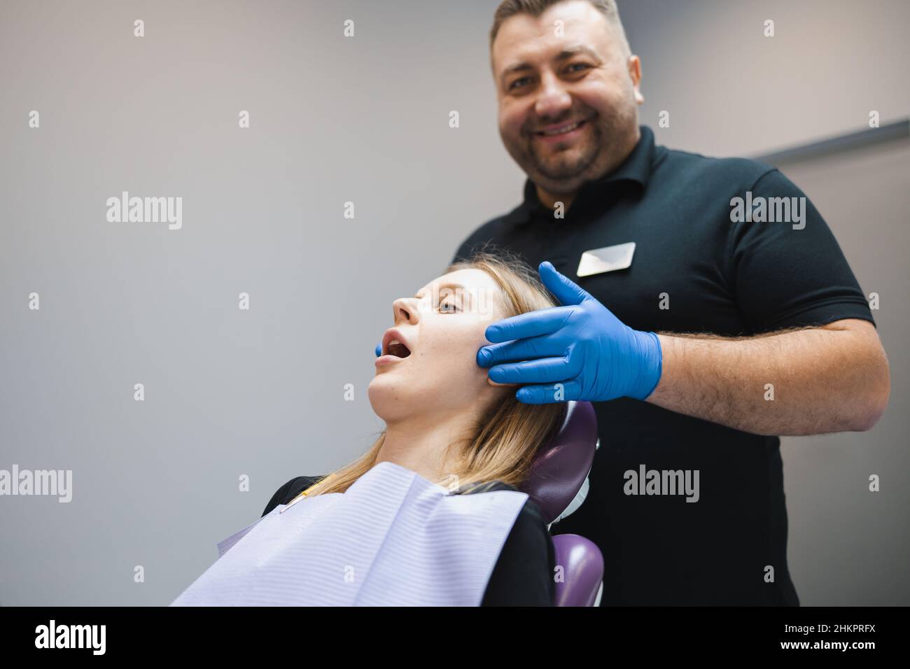 Male doctor orthodontist-gnathologist palpates the jaw joints of the ...