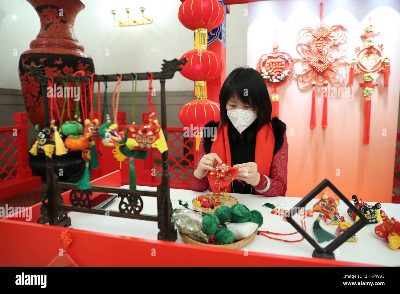 Beijing, China. 5th Feb, 2022. A craftswoman makes handicrafts during ...