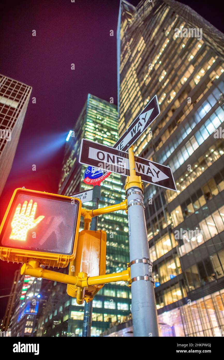 Pedestrian stop sign on a Midtown Manhattan traffic light at night ...