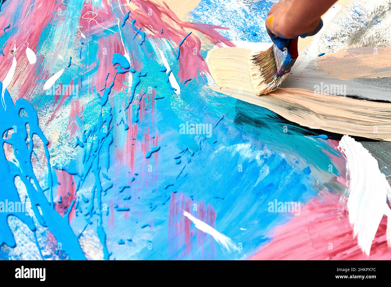 Drip painting expression art on canvas with blue, pink and beige colors ...