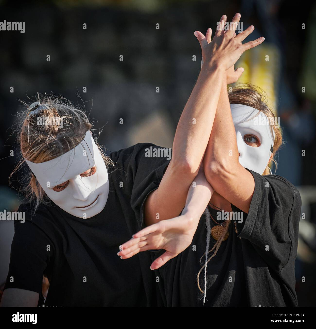 Two women in white theatre mask dancing on art theatrical festival ...