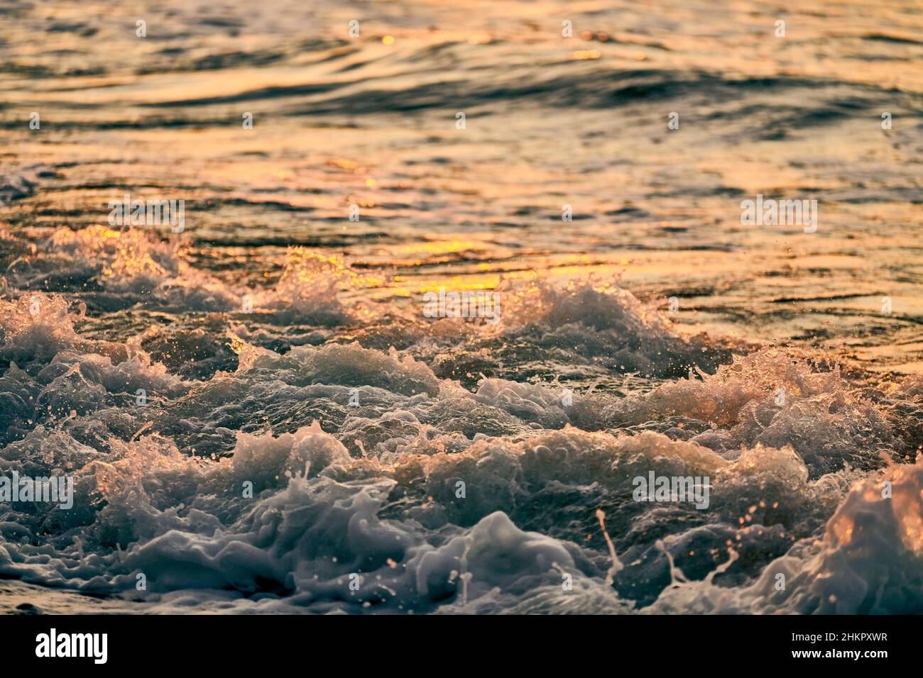 Atmospheric sea foam at colorful sunset, beautiful scene of deep sea ...
