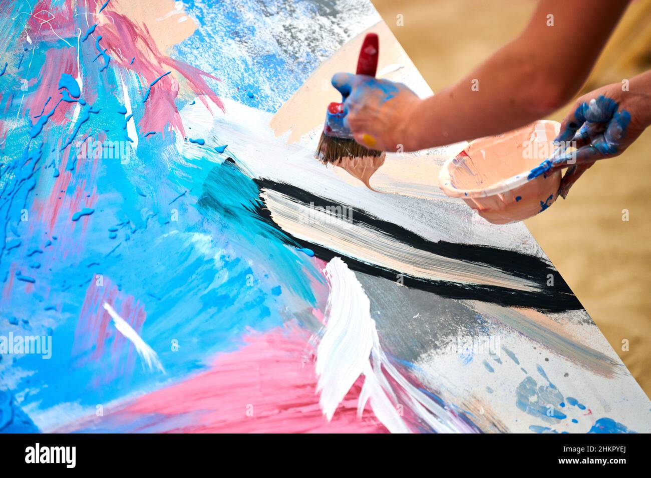 Drip painting expression art on canvas with blue, pink and beige colors ...