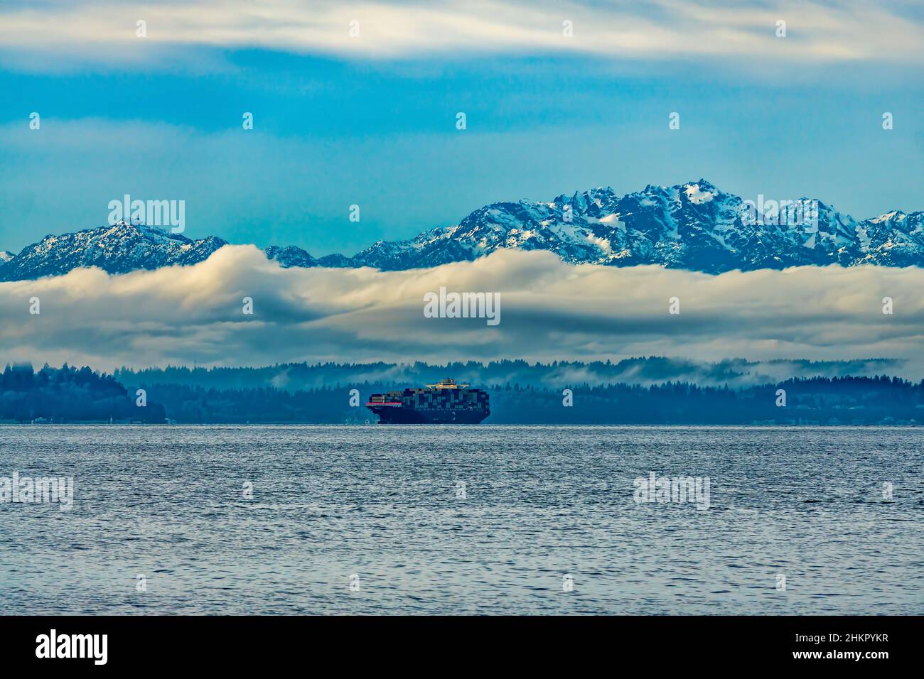 A ship crossed the Puget Sound with the Olumpic Mountain Range behind ...