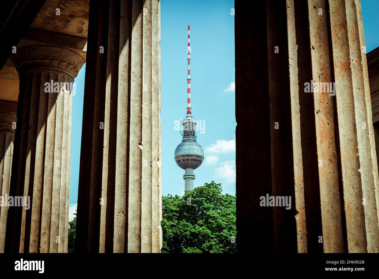 The Fernseh Turm in Berlin seen between old architectural columns on a ...