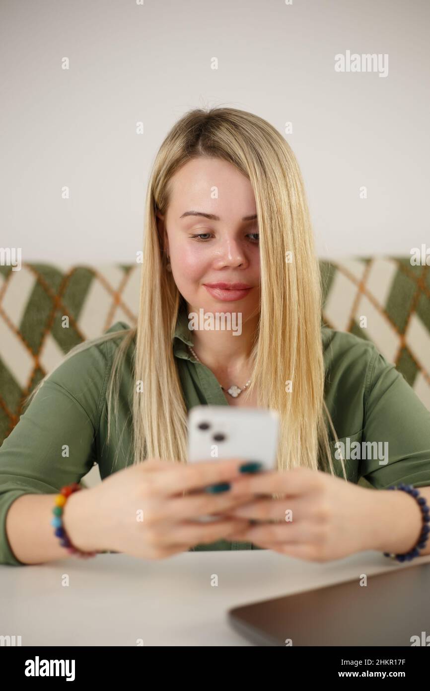 Cheerful domestic abuse victim communicating online with new mobile ...