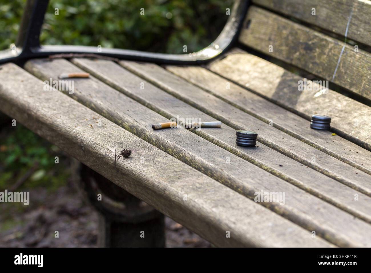 Park bench with cigarettes and bottle caps left on seating bad habits ...