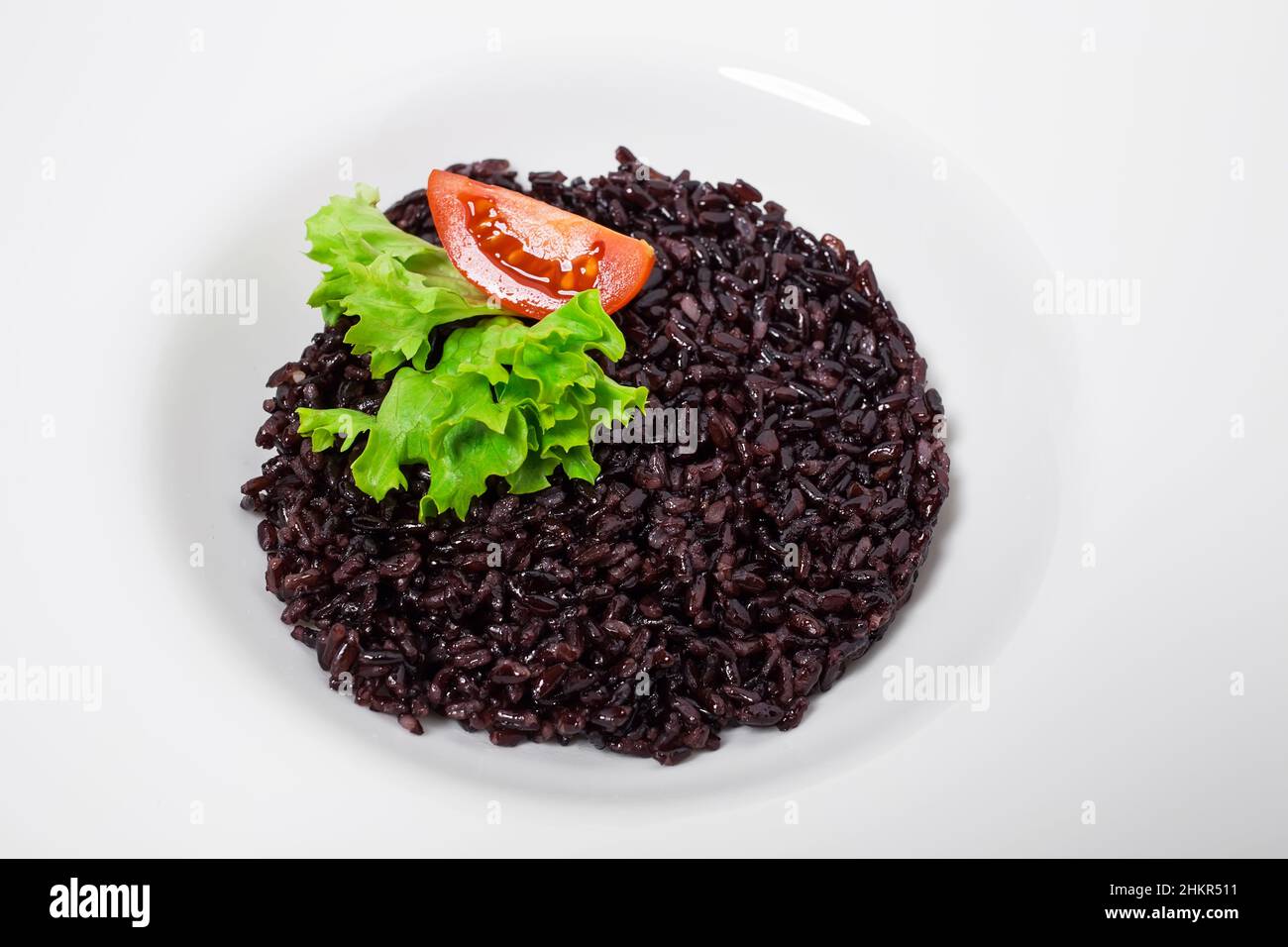 Black rice risotto with tomato. As a whole background Stock Photo - Alamy