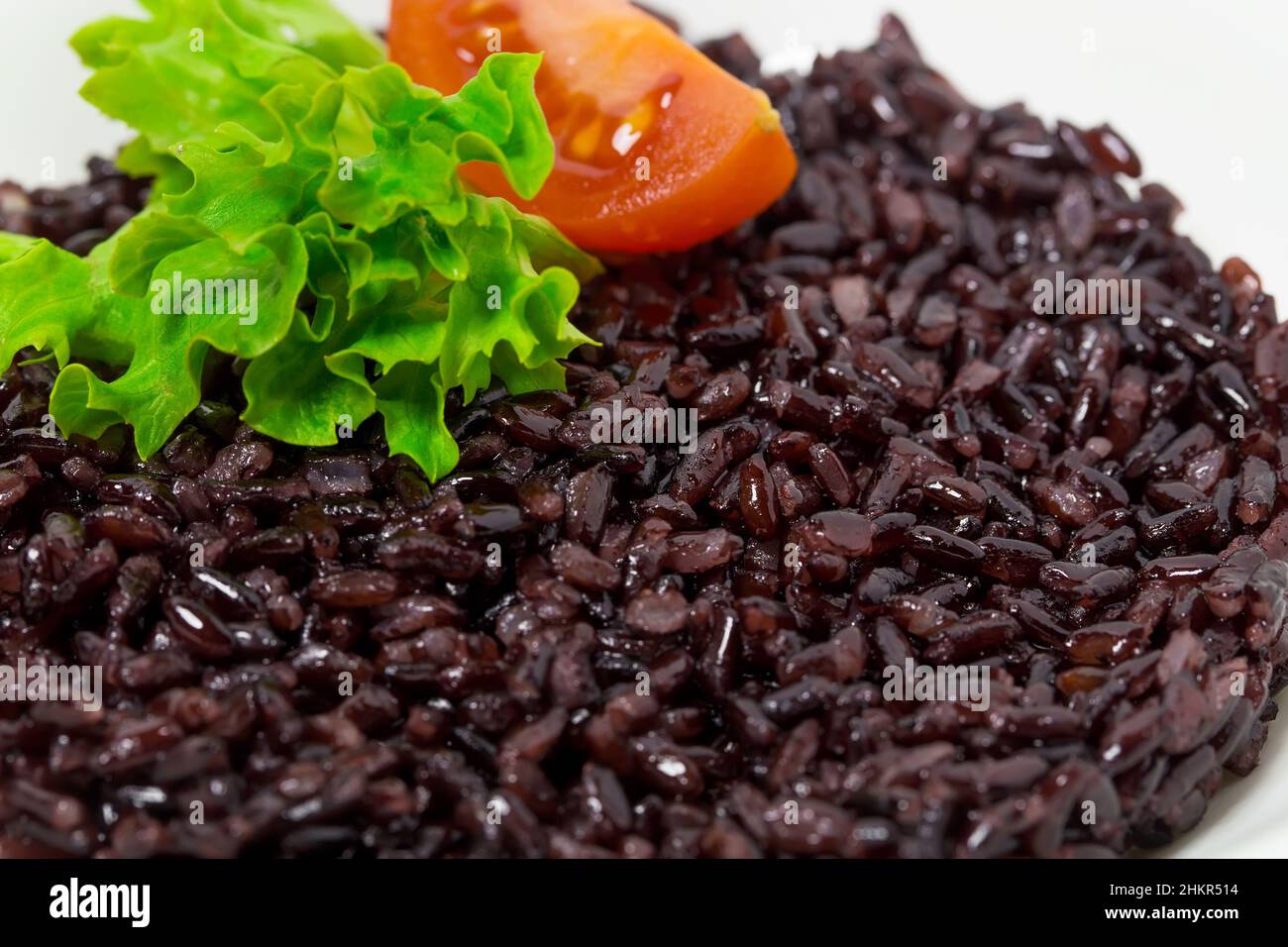 Black rice risotto with tomato. As a whole background Stock Photo - Alamy