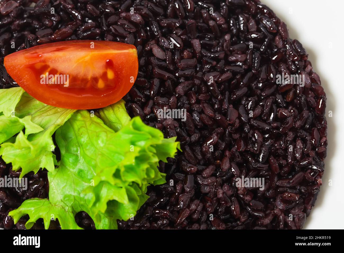 Black rice risotto with tomato. As a whole background Stock Photo - Alamy