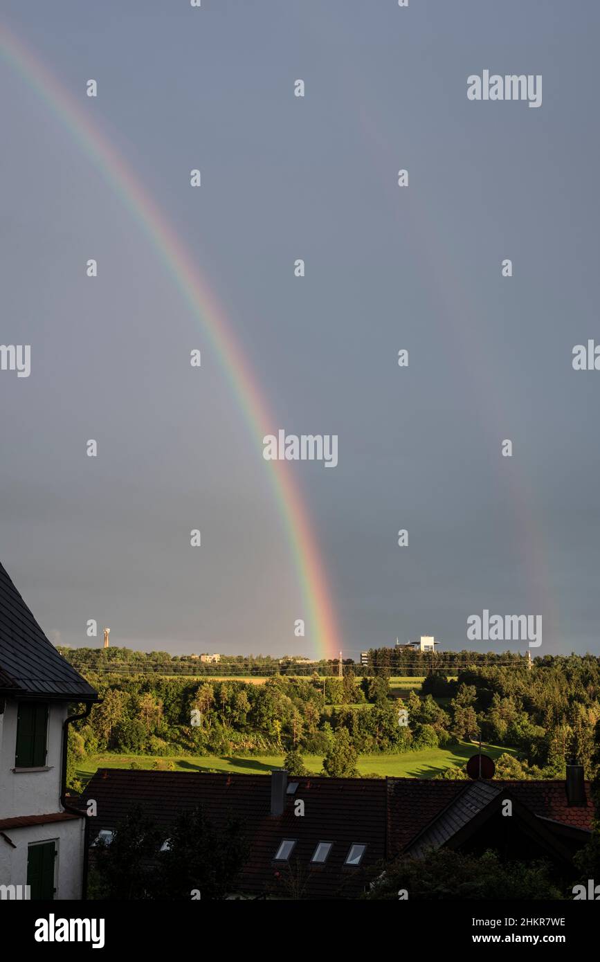 the spectrum colors of a rainbow on a summer day over woodland Stock ...