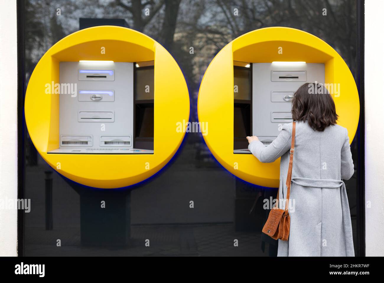 Back view of elegant woman using a modern ATM. Space for text Stock ...