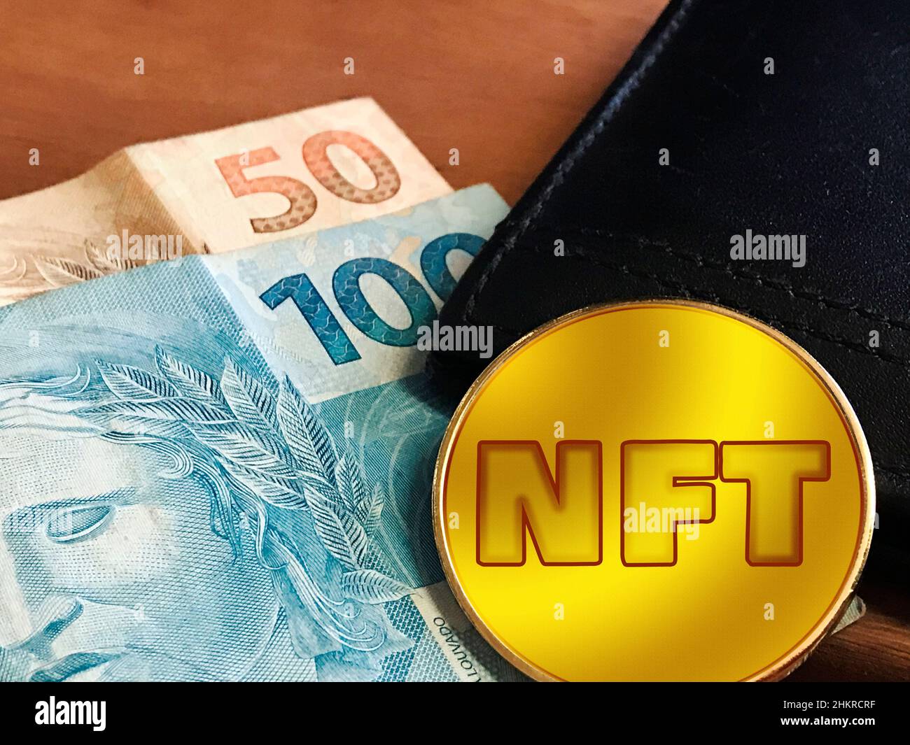 NFT Gold Coin, brazilian money and Wallet on wood table Stock Photo - Alamy