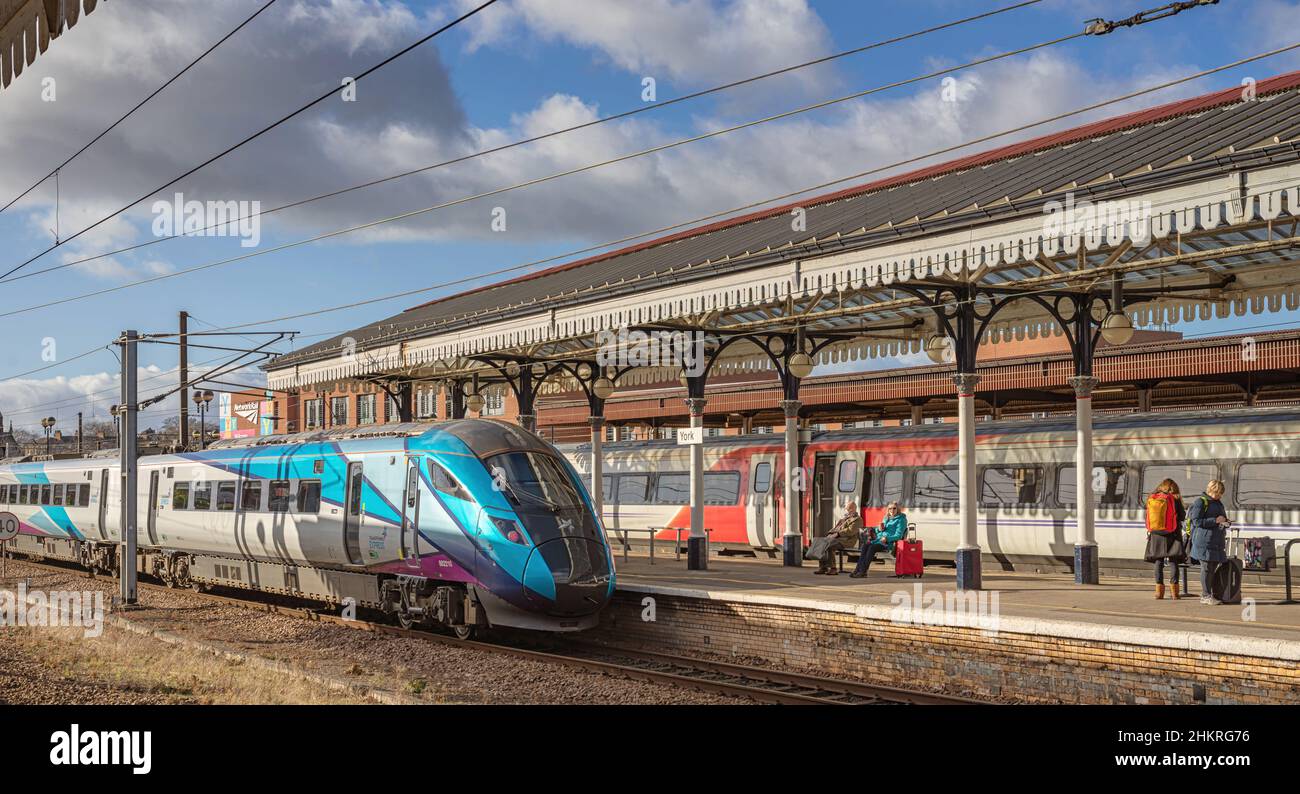 Historic railway station platform with trains alongside. A winter ...