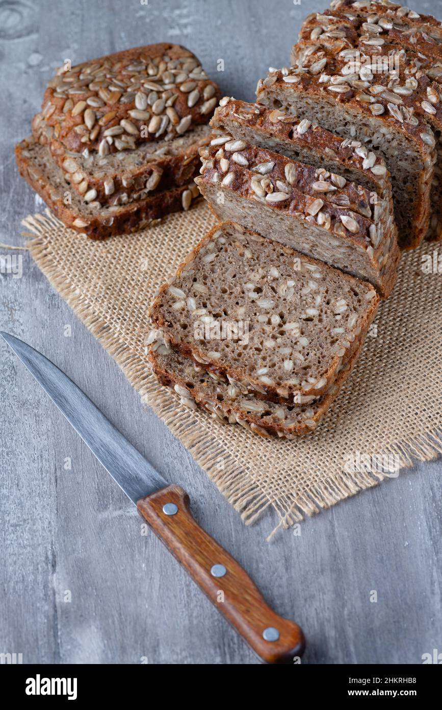 Sliced rye bread on cutting board. Whole grain rye bread with seeds ...