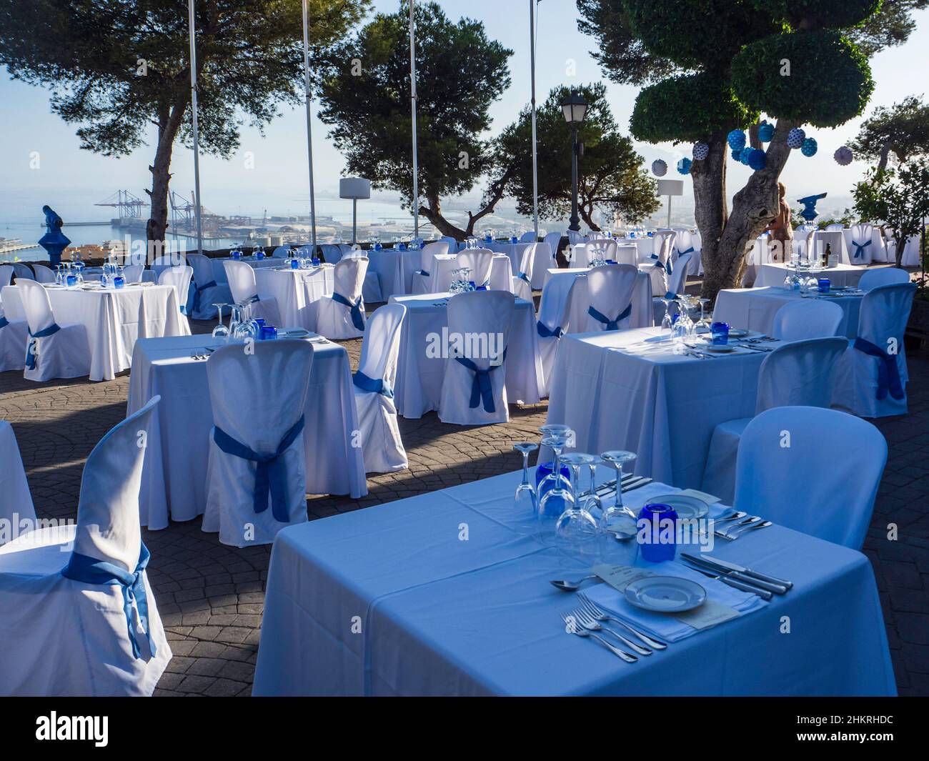 Tables dressed for celebrations in a restaurant with the bay of Malaga ...