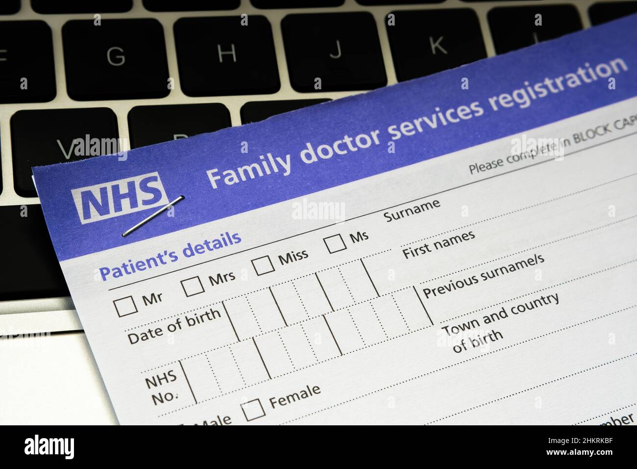 UK NHS Family doctor services registration form placed on keyboard ...