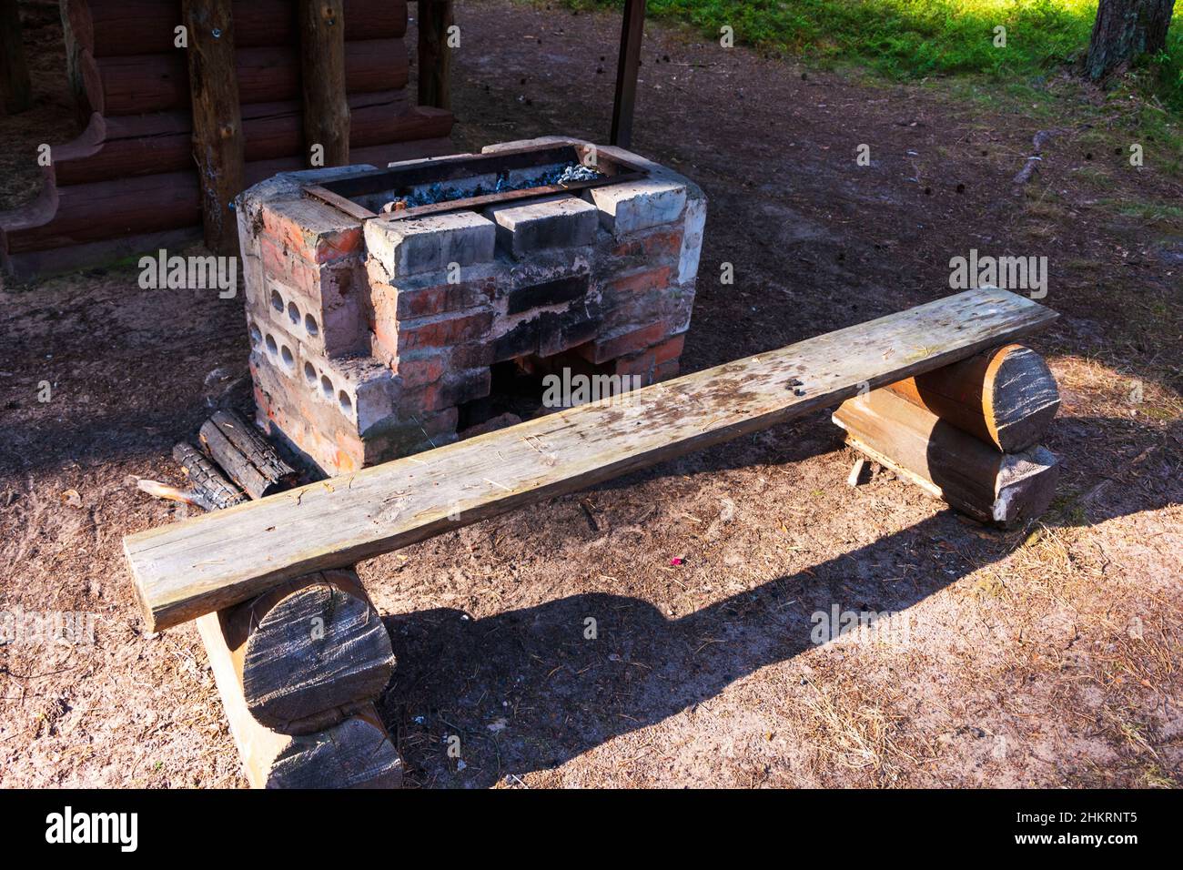 Old brick barbecue barbecue in the backyard in the summer, a bench for ...