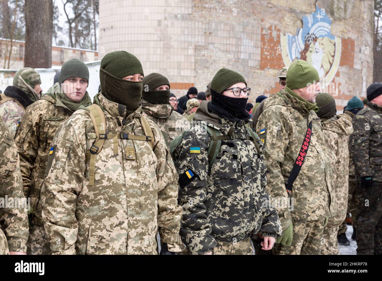 Civilians stand in line during Territorial Defence Force exercise while ...