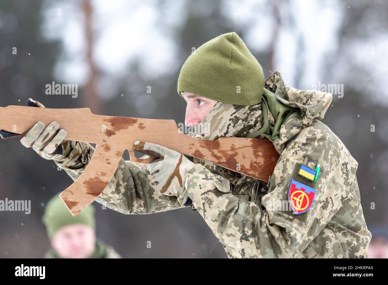 A civilian holds a rifle during Territorial Defence Force exercise ...