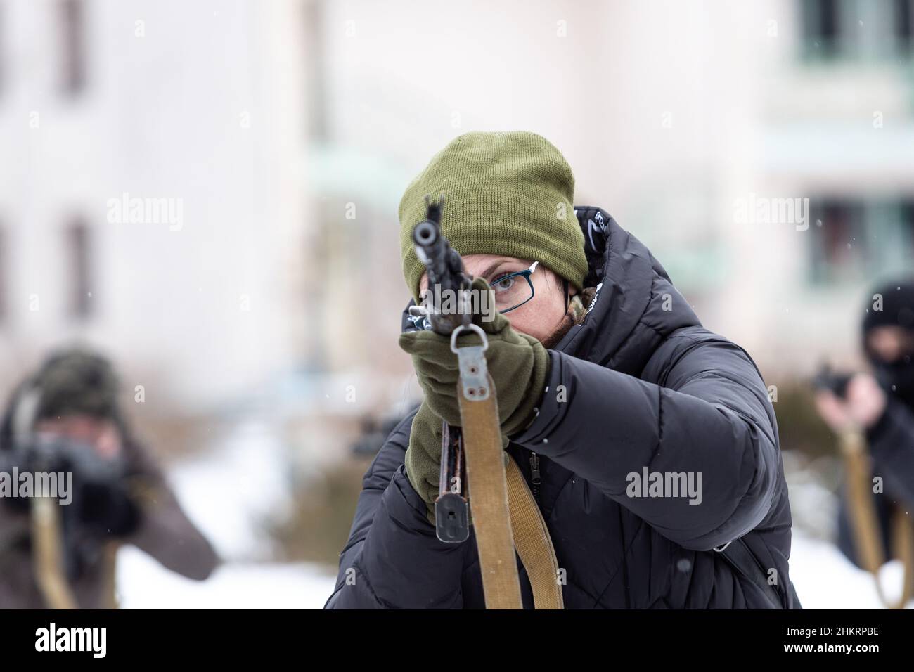 A civilian holds a rifle during Territorial Defence Force exercise ...