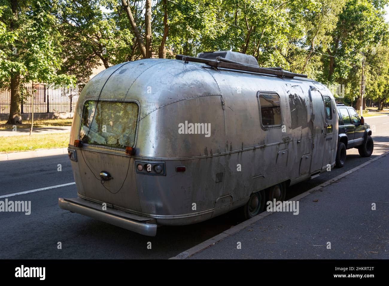 An old American car trailer made of aluminum hooked to an old American ...