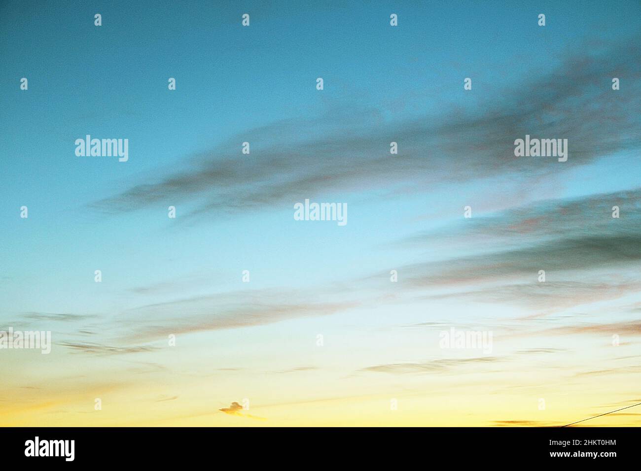 Clouds in the sky are illuminated from below by the light of the sun ...